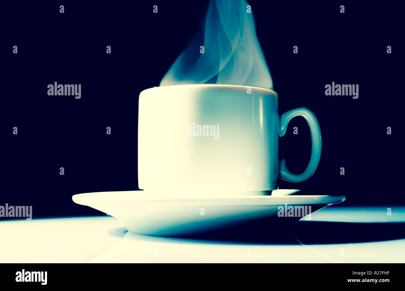 Cup of coffee with a beautiful smoke steam fume close-up on a black ...