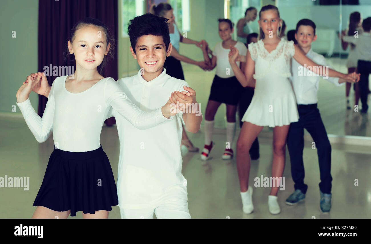 Group of positive smiling american children dancing salsa in school ...