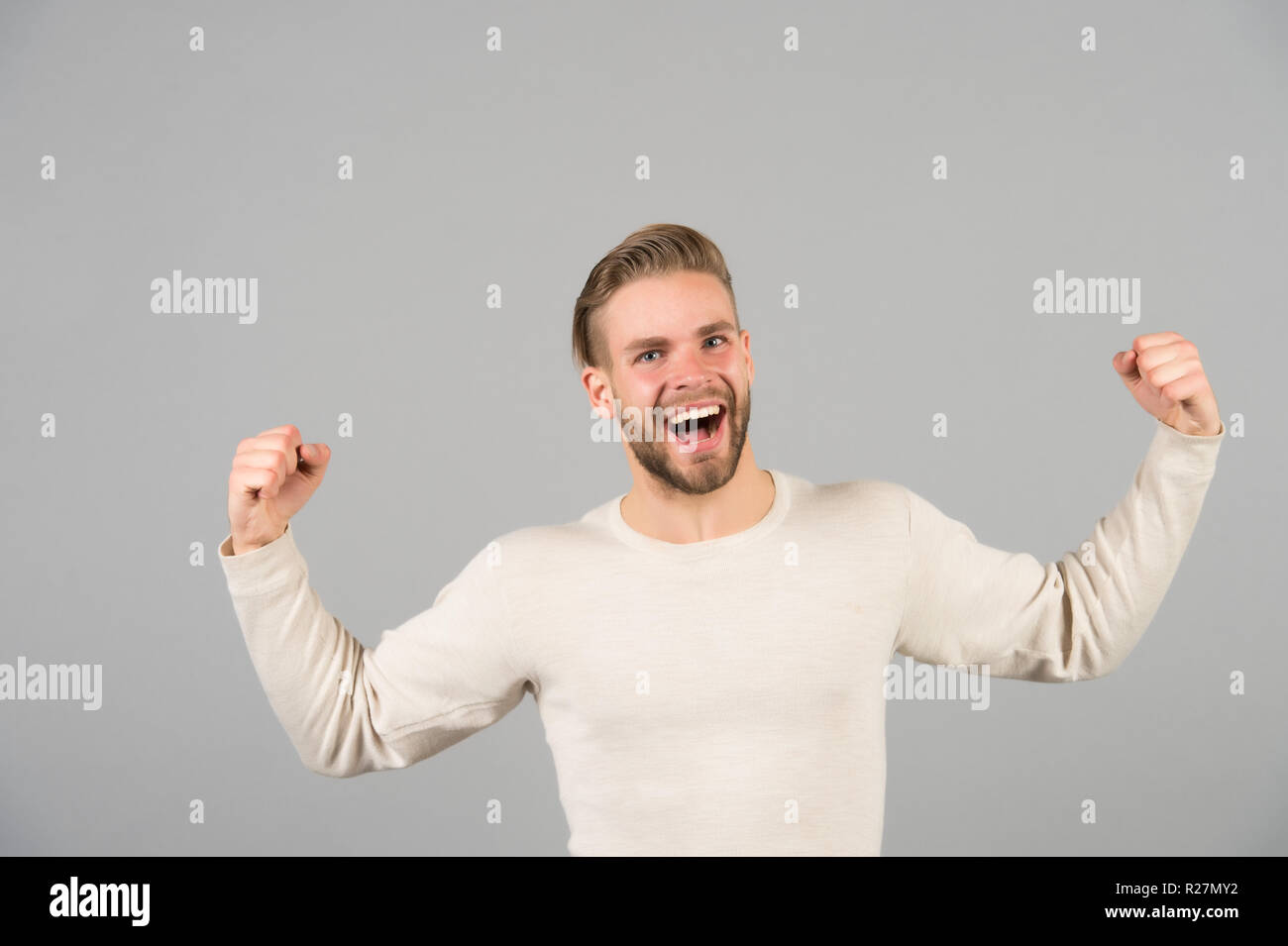 Cheerful winner. Man happy cheerful face posing with muscles as winner ...