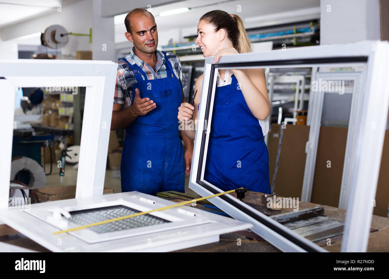 smiling italian foreman explaining plastic windows assembly process to ...