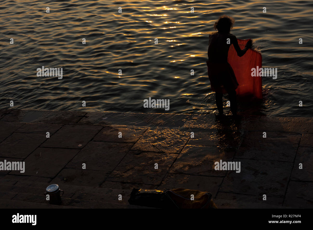 Morning ritual and washing at sunrise along the bank of the river ...
