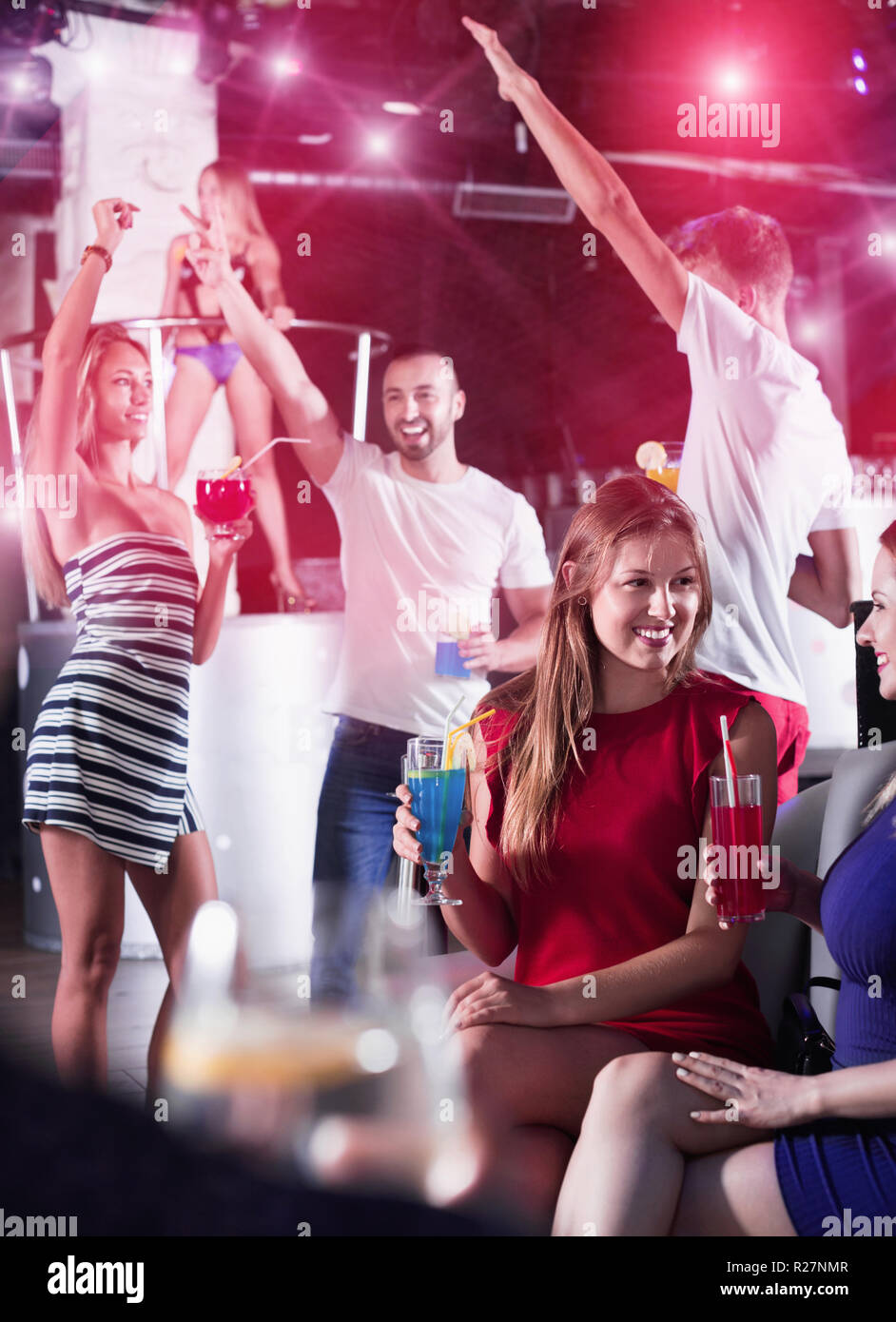 Happy cheerful positive smiling females talking on party in the club ...