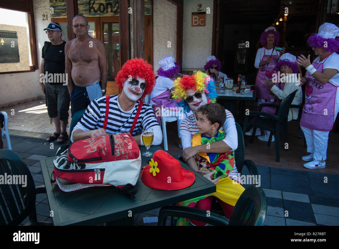 Carnival clown face hair stripes shirt red hair cap smiling face man ...