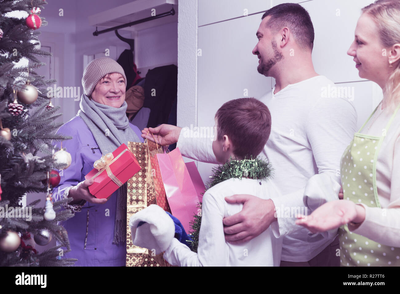 Happy senior woman visiting family of her son for celebration of New ...