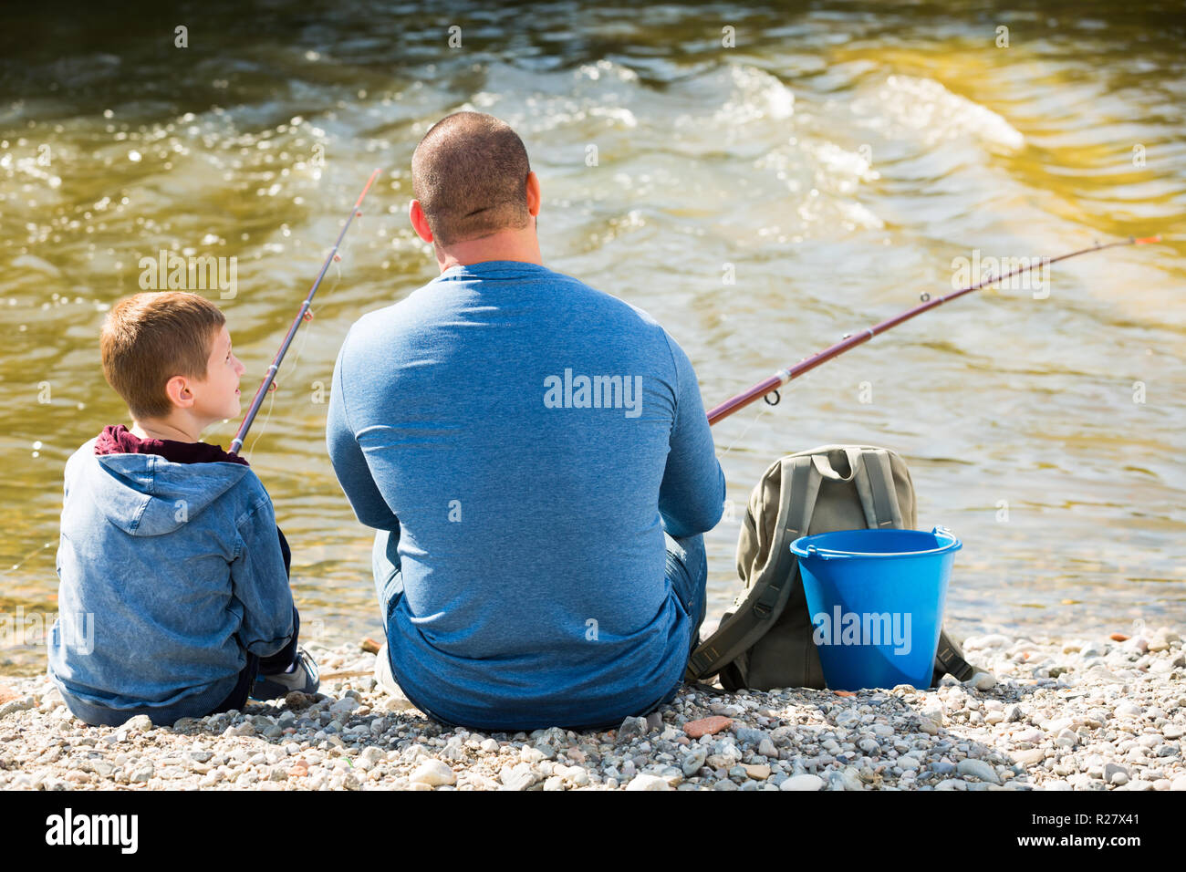 Father and son fishing with rods in summer day Stock Photo - Alamy
