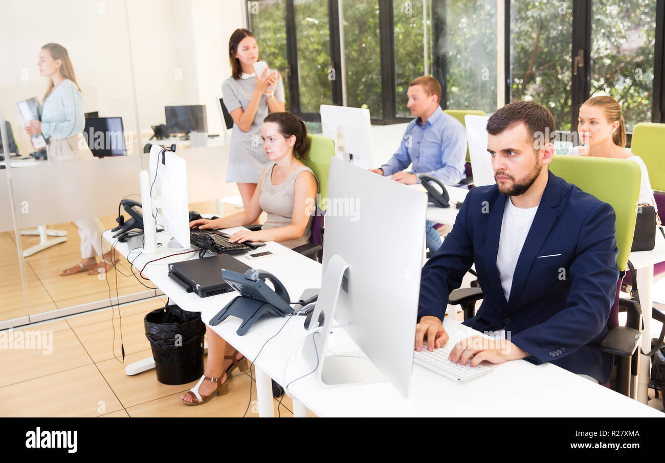 Young successful coworkers engaged in business activities in modern ...