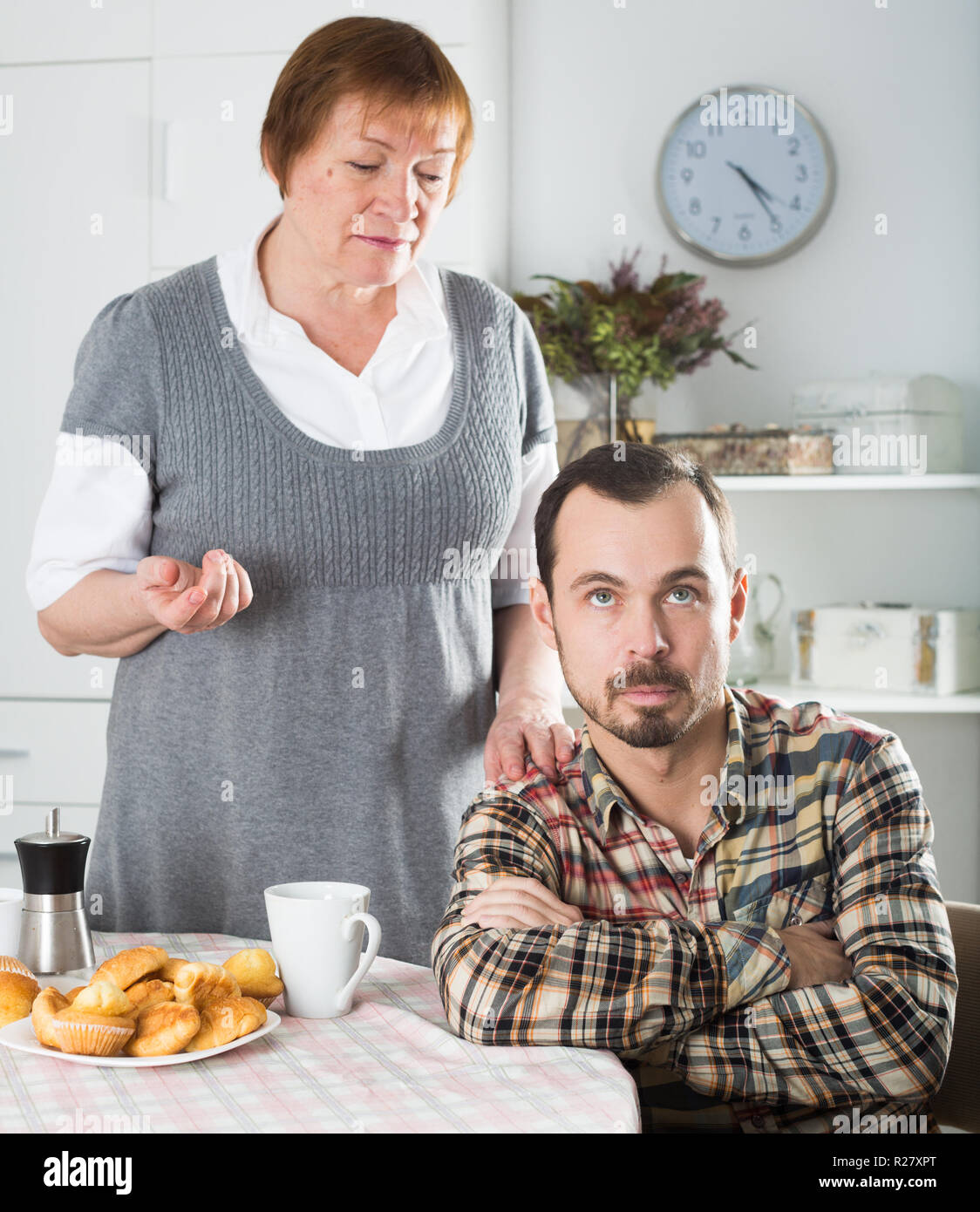 Aged mother arguing with her adult son at home Stock Photo - Alamy