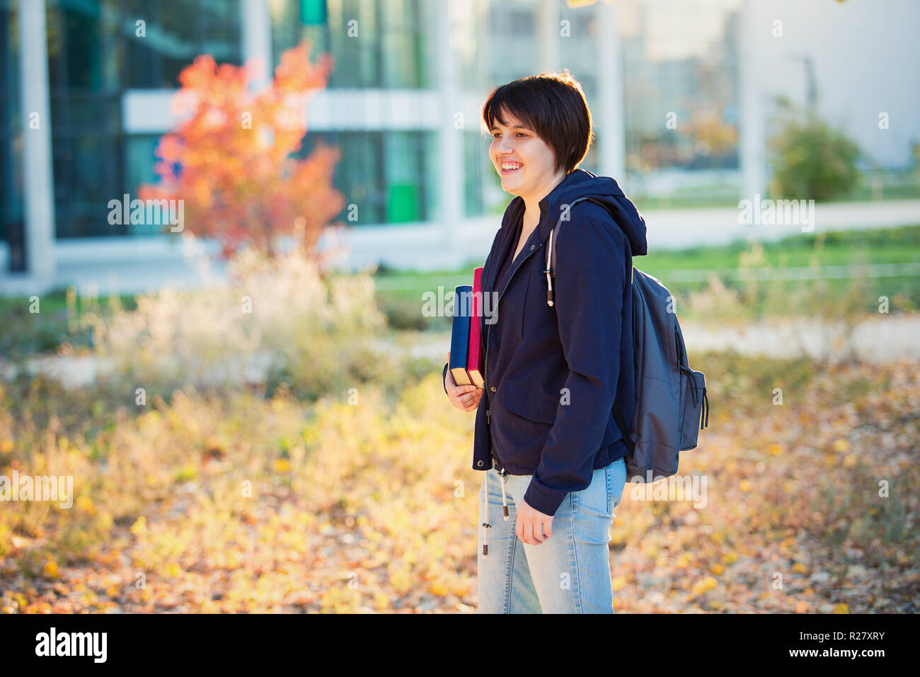 Student girl going to college, outdoor portrait, holding books and ...