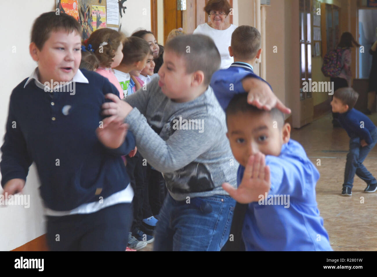 School children at recess in the hallway. Boys playing in the hallway ...