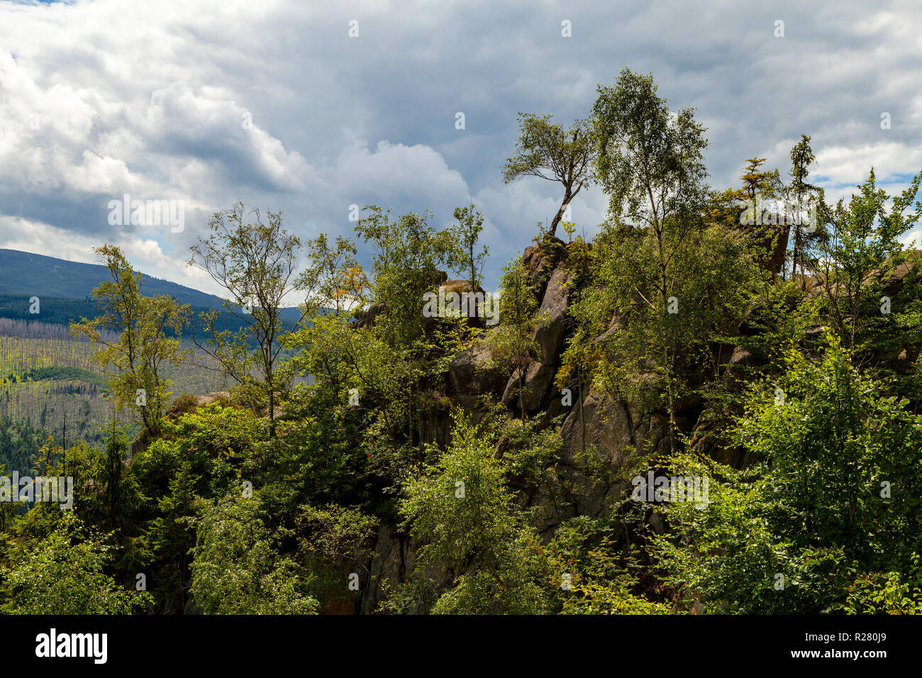 Rockface and a view of the Brocken Mountain in the Harz region in ...