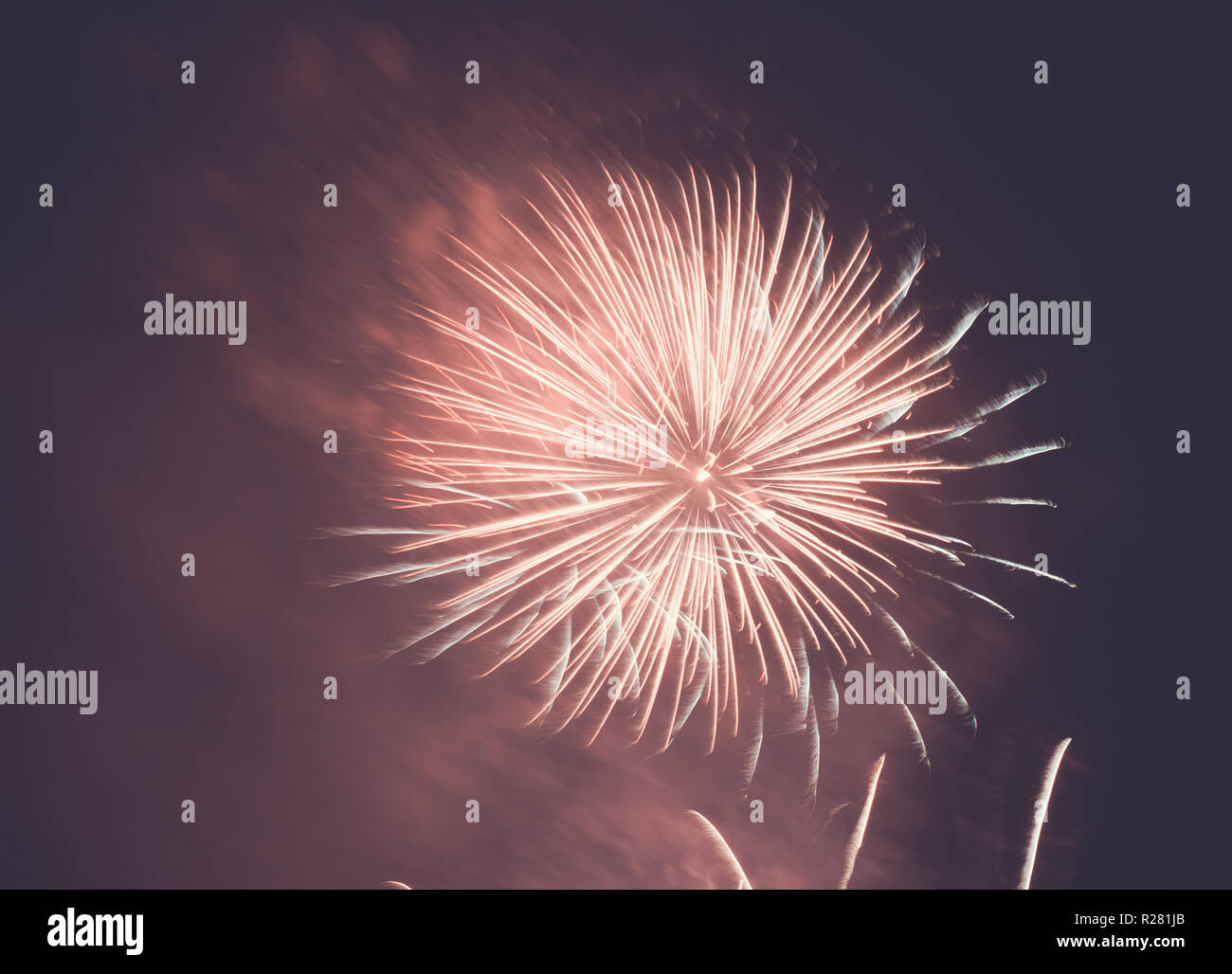 Bright pink firework show against background of dark sky Stock Photo ...