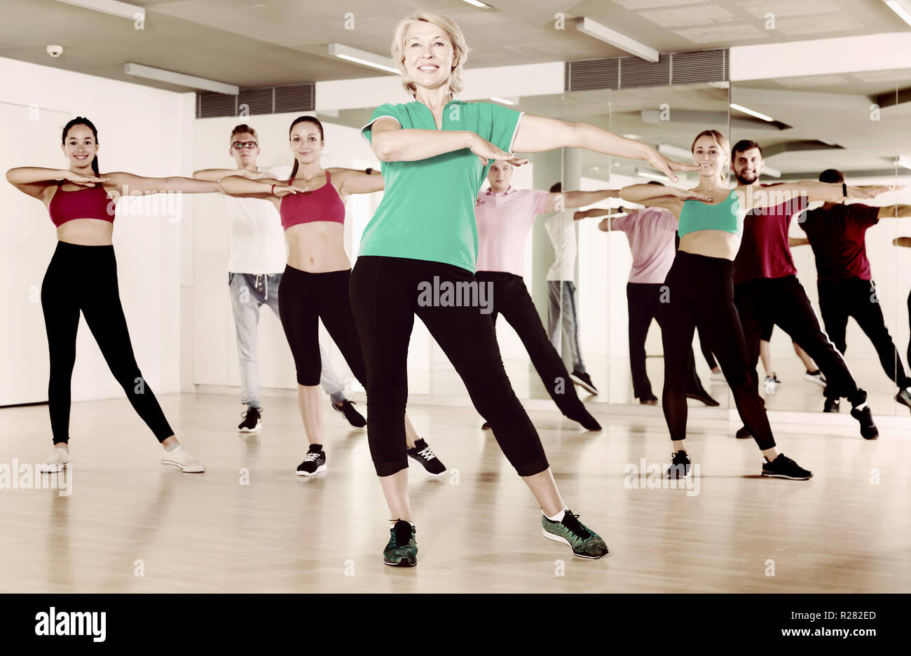 Positive people of different ages dancing in studio Stock Photo - Alamy