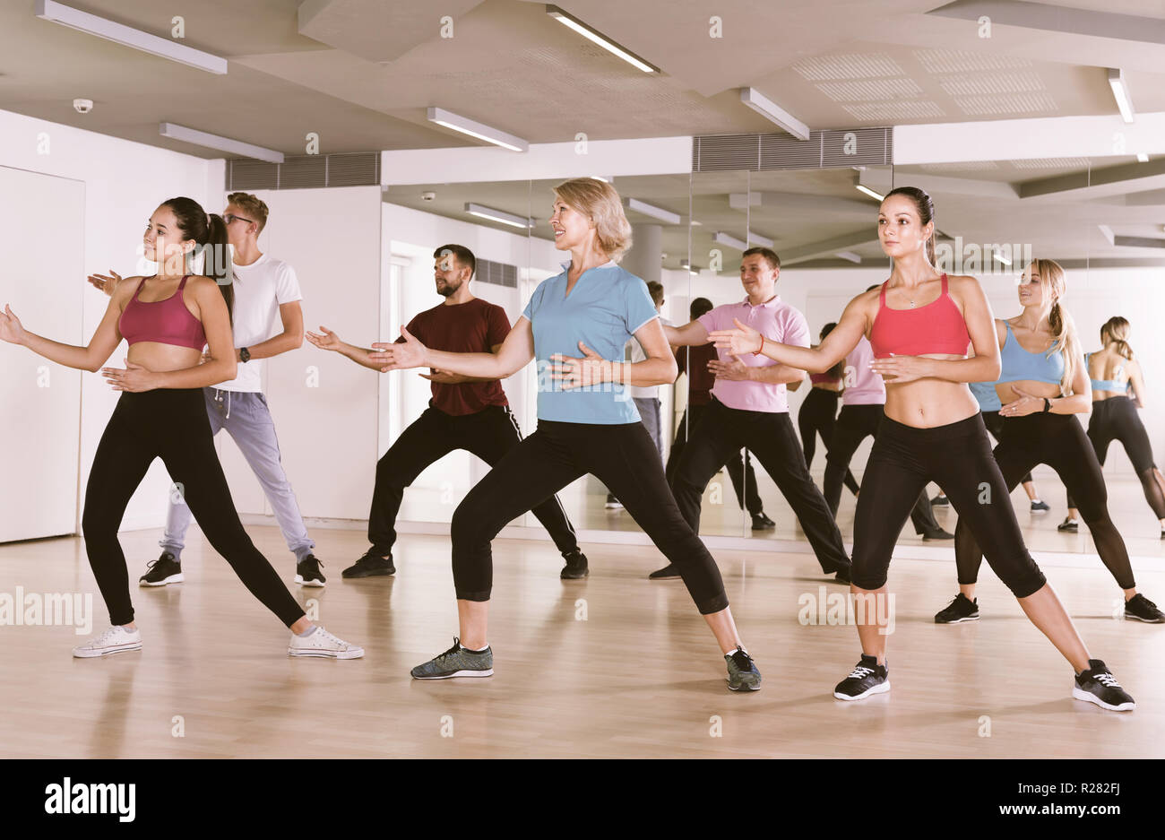 Positive people of different ages dancing in modern studio Stock Photo ...