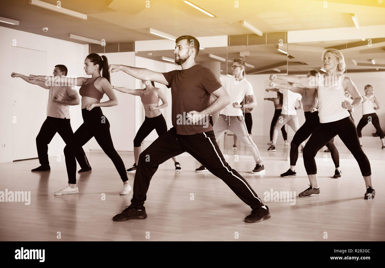 Group of active people practicing together in studio Stock Photo - Alamy