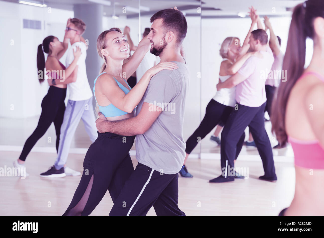 Joyful dancing pair dance together in studio Stock Photo - Alamy
