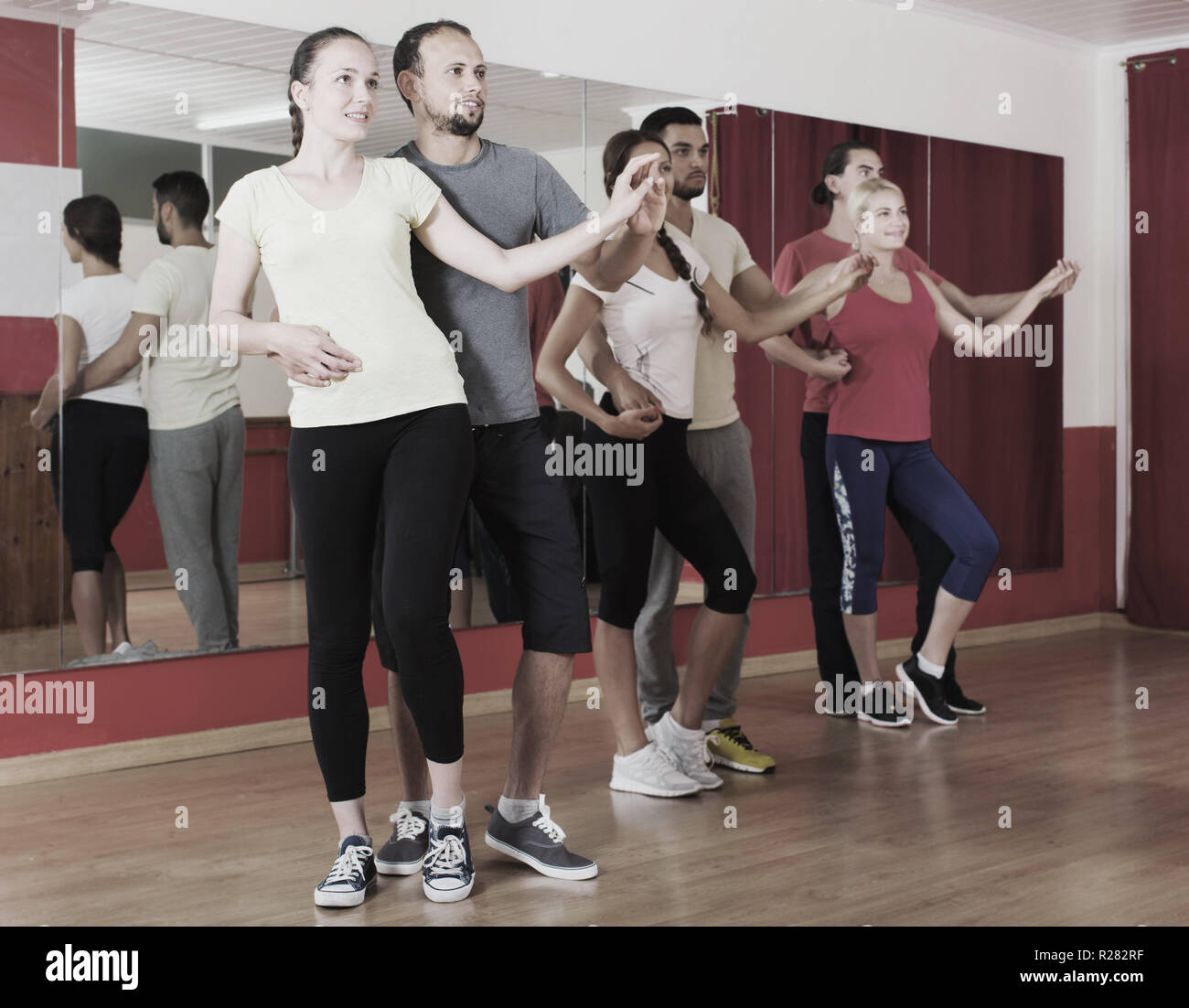 Group of people dancing salsa in studio Stock Photo - Alamy