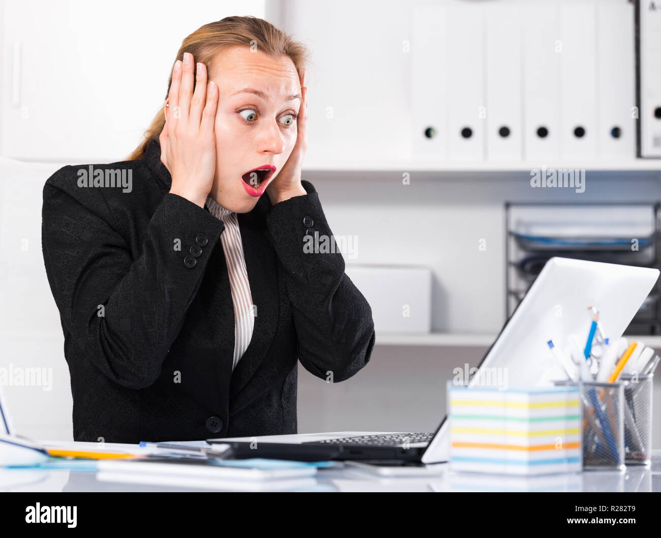 Busy businesswoman in suit worrying at the computer Stock Photo - Alamy