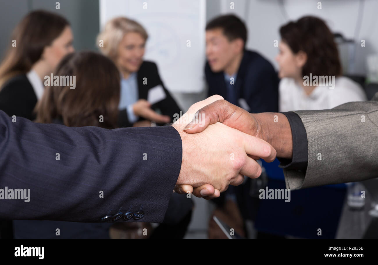 Closeup of businessmen handshake as sign of closing deal on meeting ...