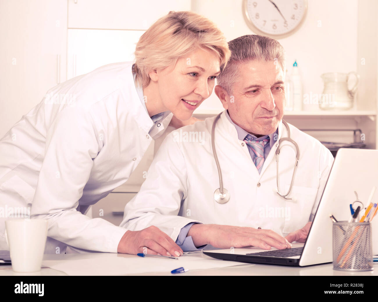 Doctor and nurse check patient data in hospital computer database Stock ...