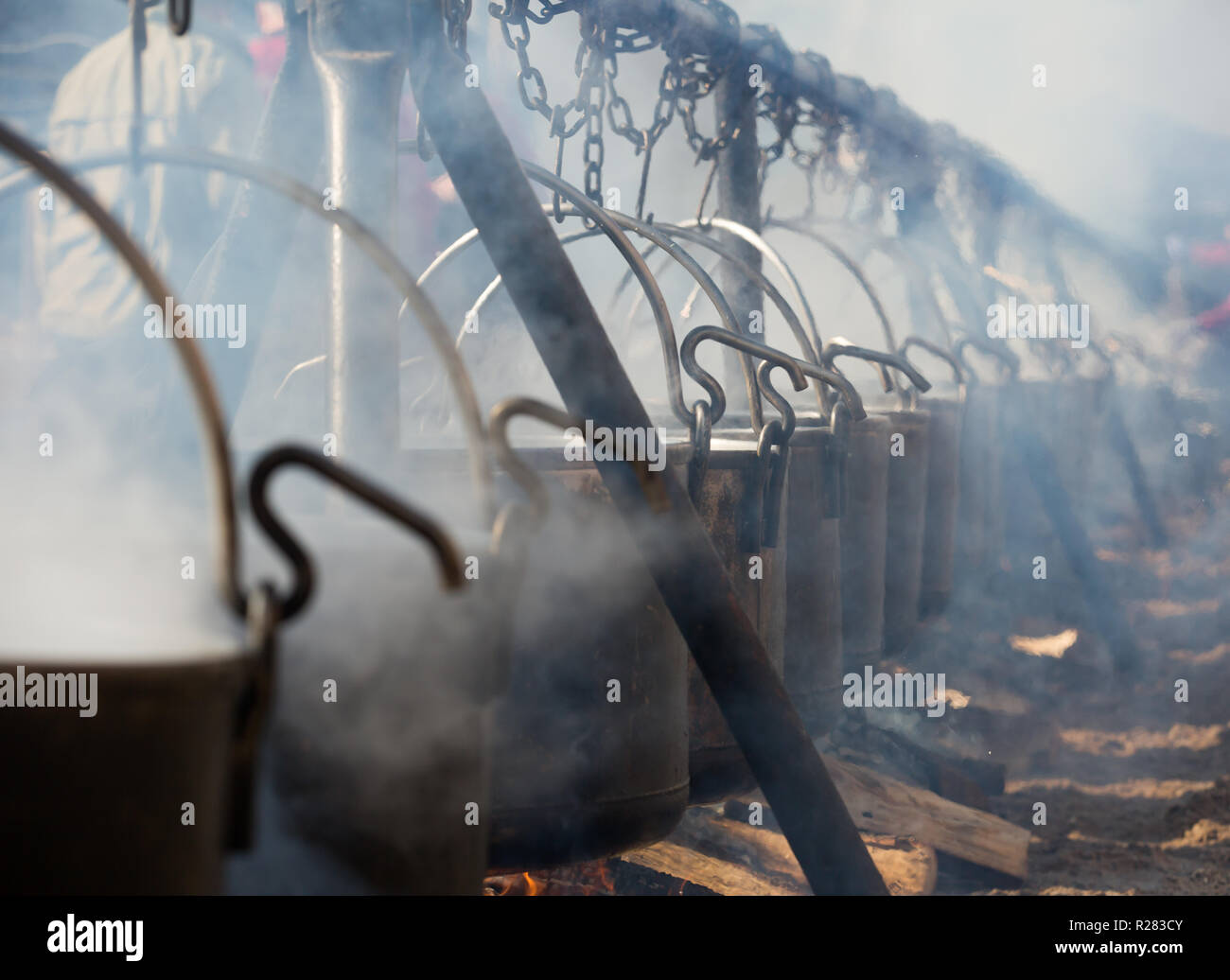 View of iron cauldrons for cooking outdoors in medieval style in open ...