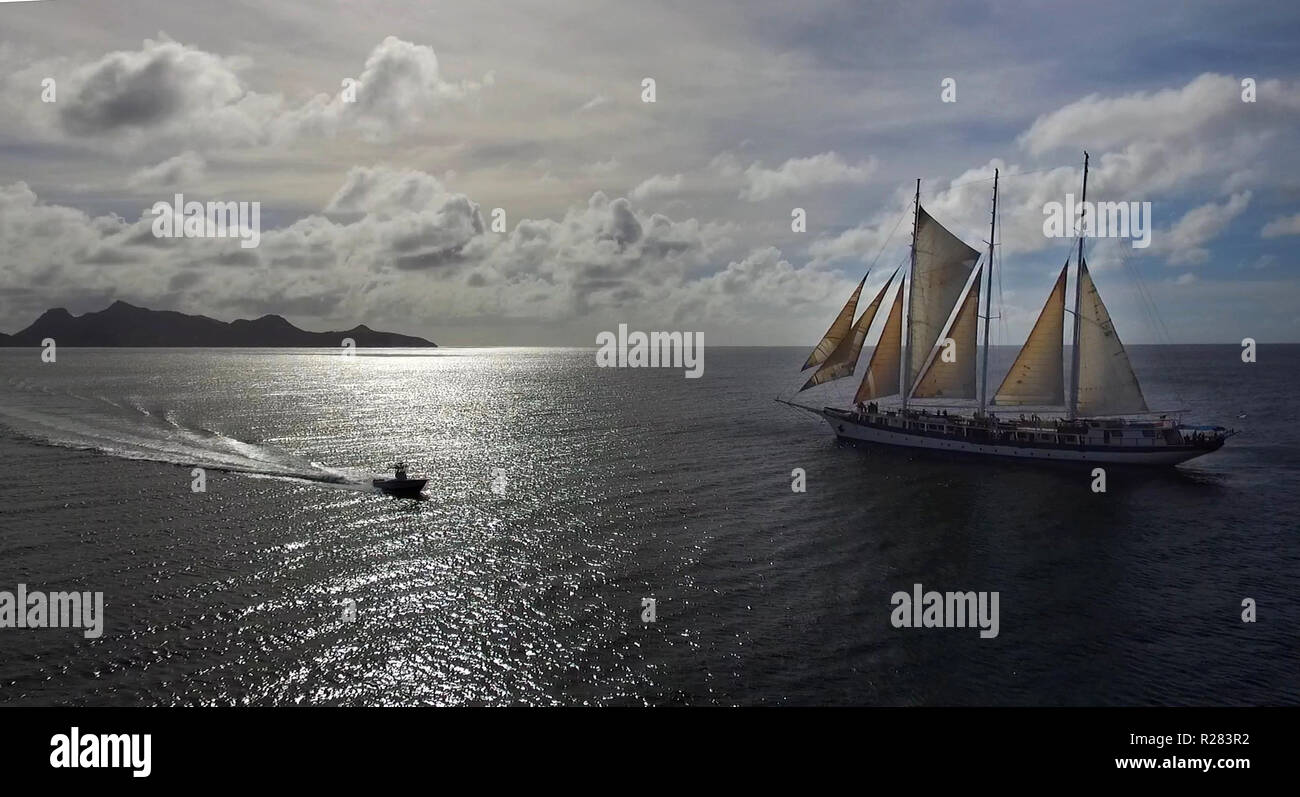 Aerial drone birds eye view of boat cruising in tropical waters at ...