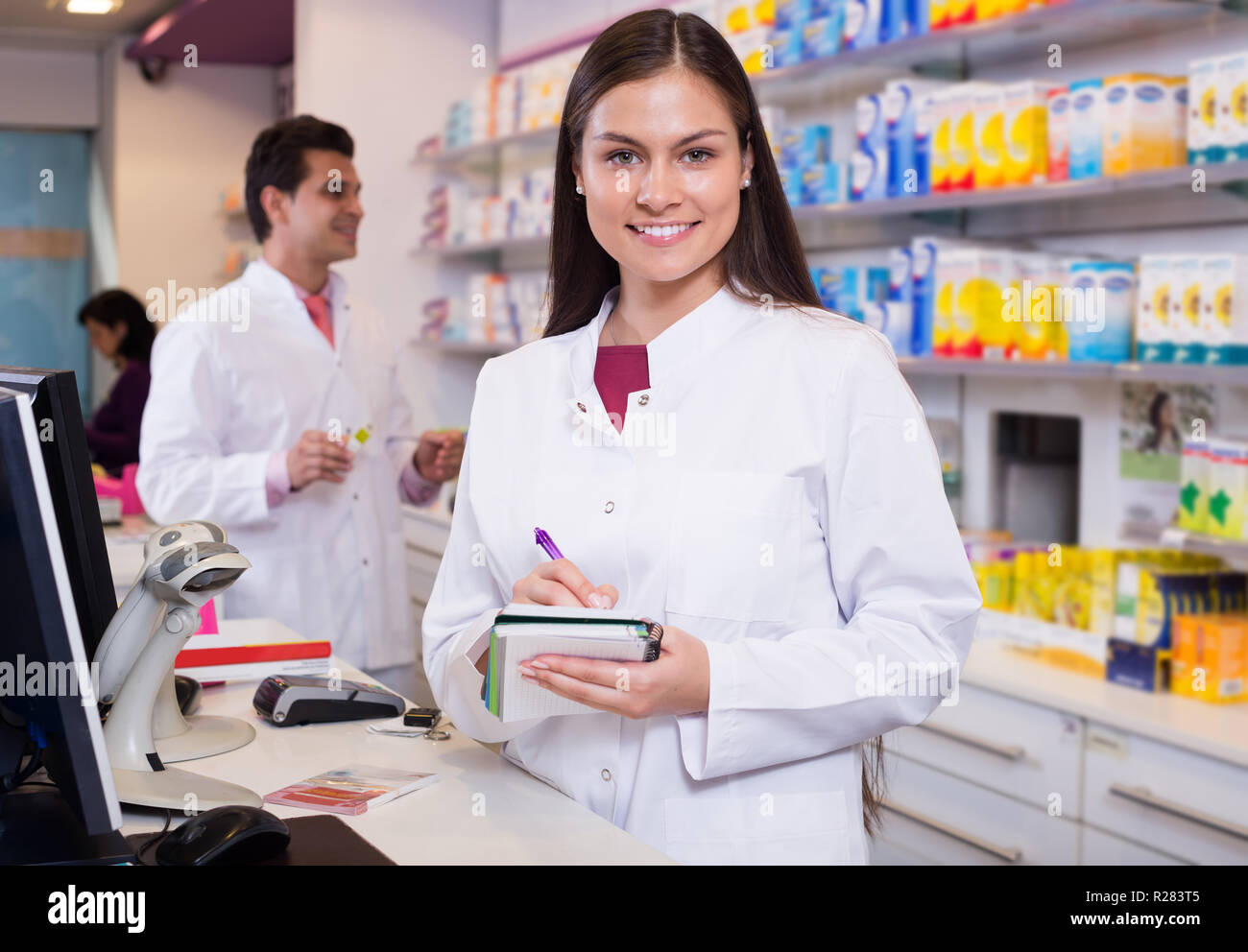 Professional european pharmaceutists at reception of drugstore ready to ...