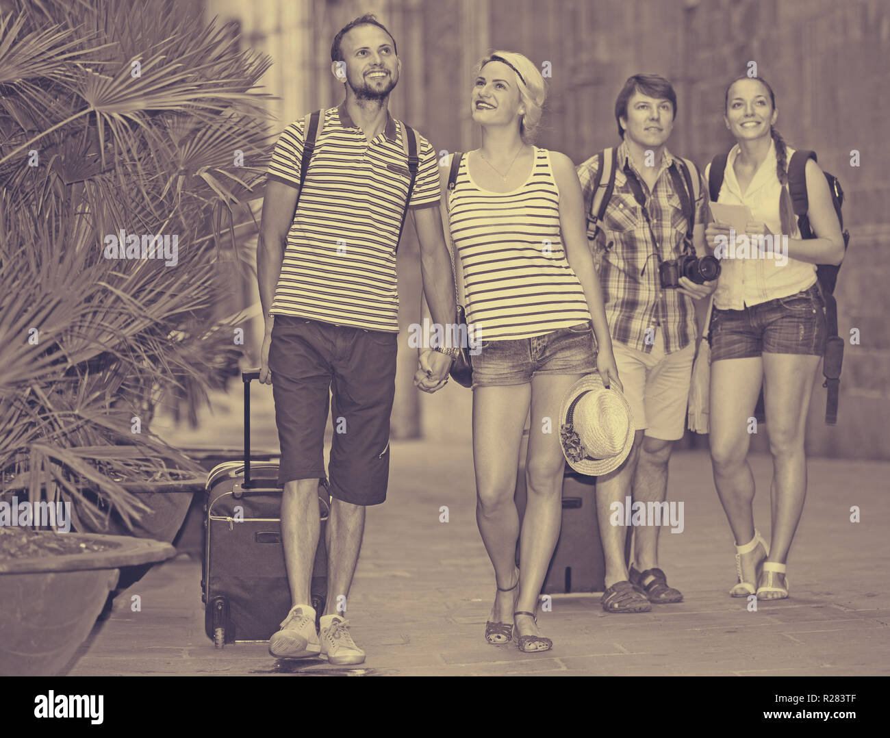 Happy tourists watching landmark at the street at summer vacation Stock ...