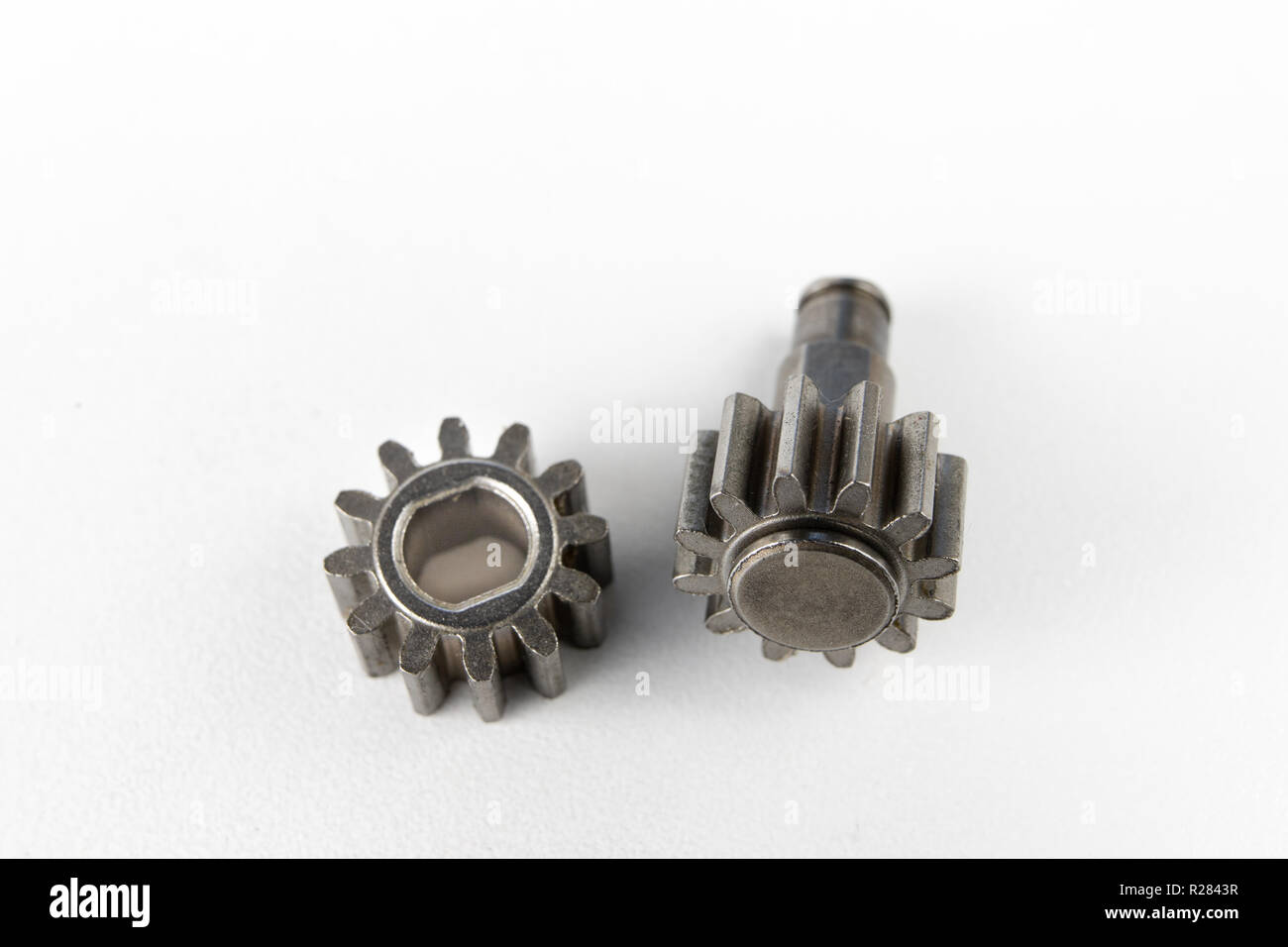 Wheels for mechanical gears on a white workshop table. Mechanical parts ...