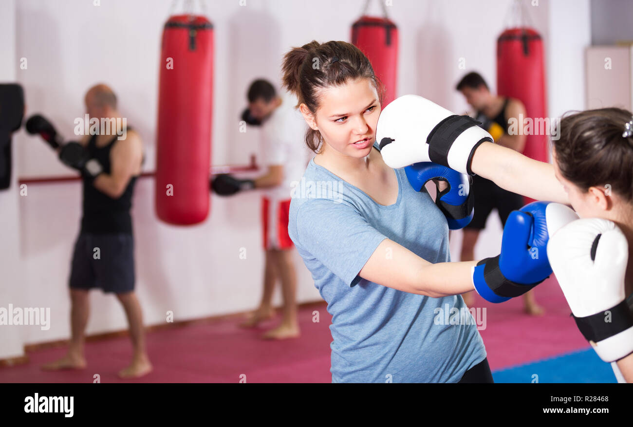 Sportswoman is having sparring with partner in the boxing hall Stock ...
