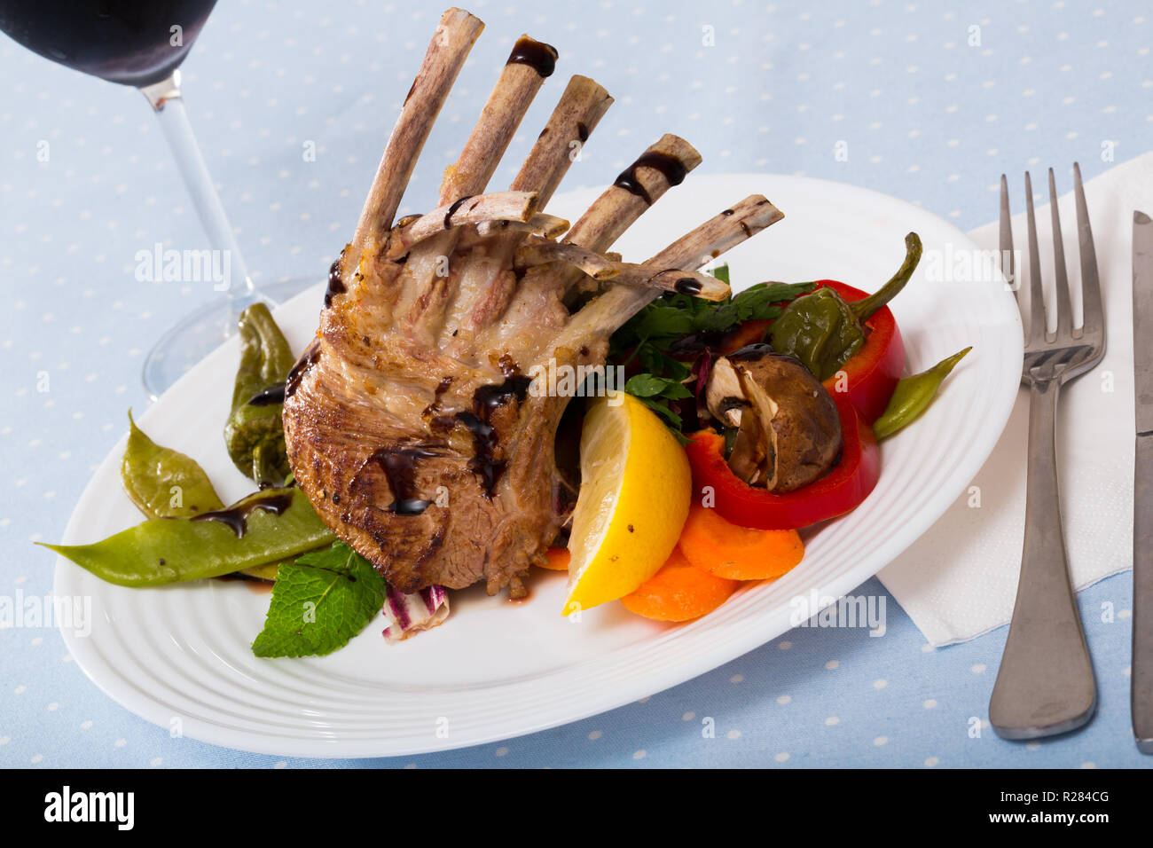 Rack of mutton chops surrounded by assorted fresh vegetables and mint ...