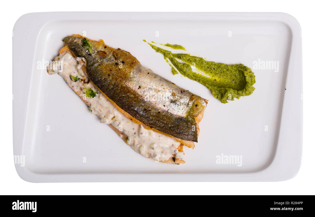 Top view of fried river trout fillets with tartare sauce and broccoli ...