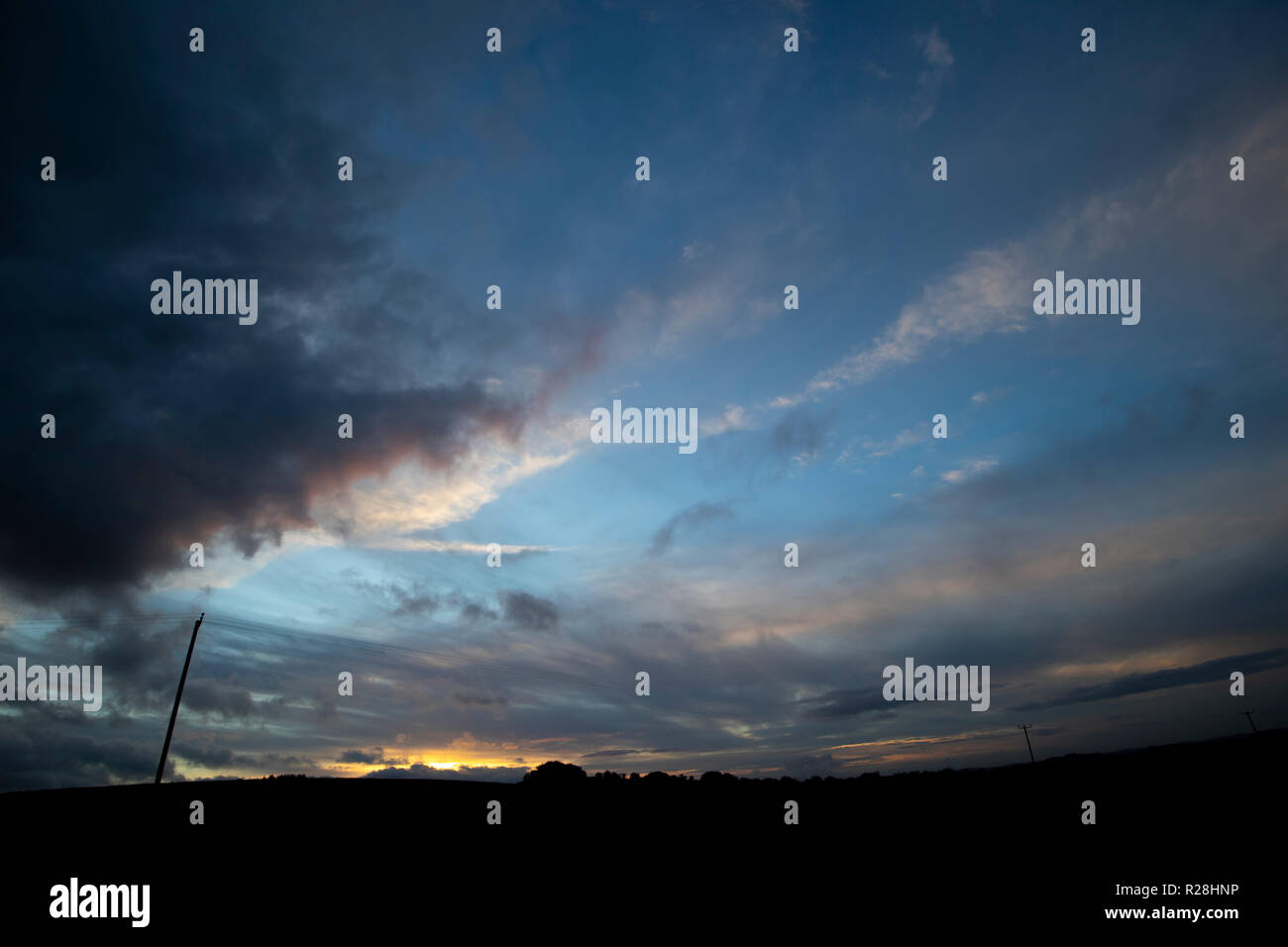 Dusk over farmland in the rural county of Hampshire with tree lined ...
