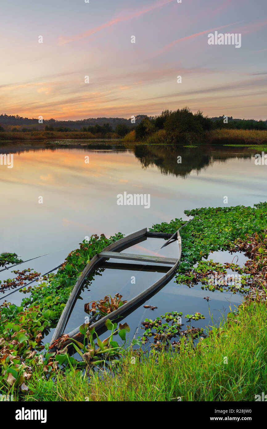 Natural landscape with boats in the water at sunset. Amazing lake with ...