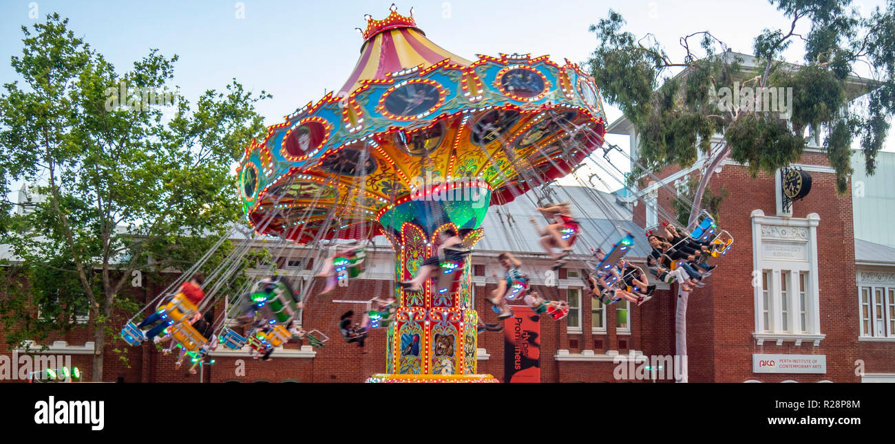 People riding a swing carousel ride Christmas festival Perth Cultural ...