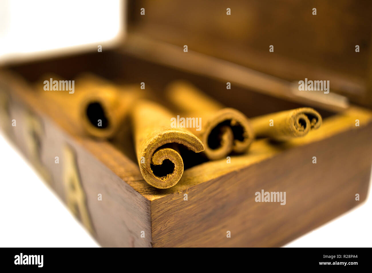 Cinnamon sticks in box isolated on white background. Selective focus ...