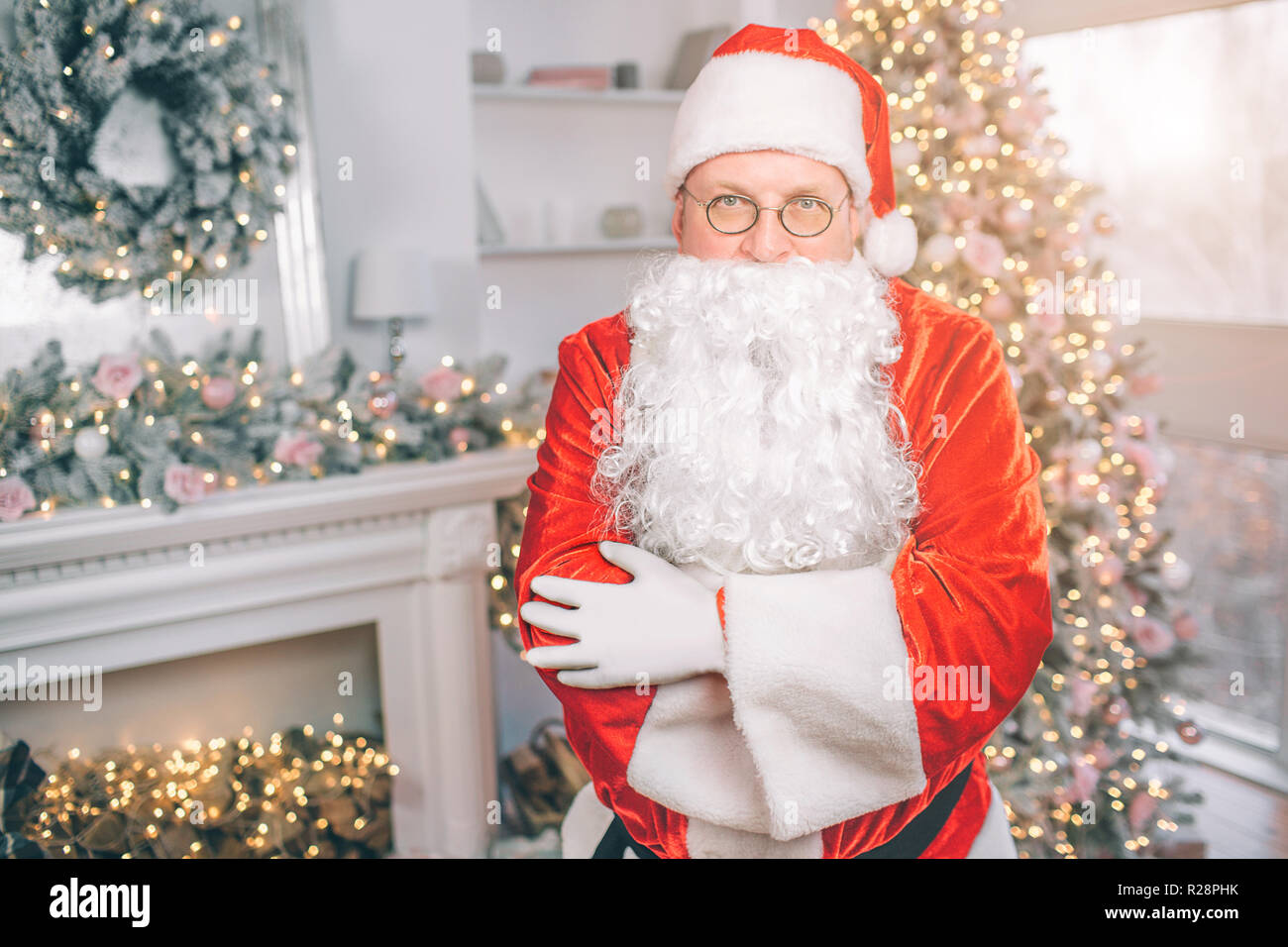 Serious man in Santa Claus clothes standing and posing on camera. He ...