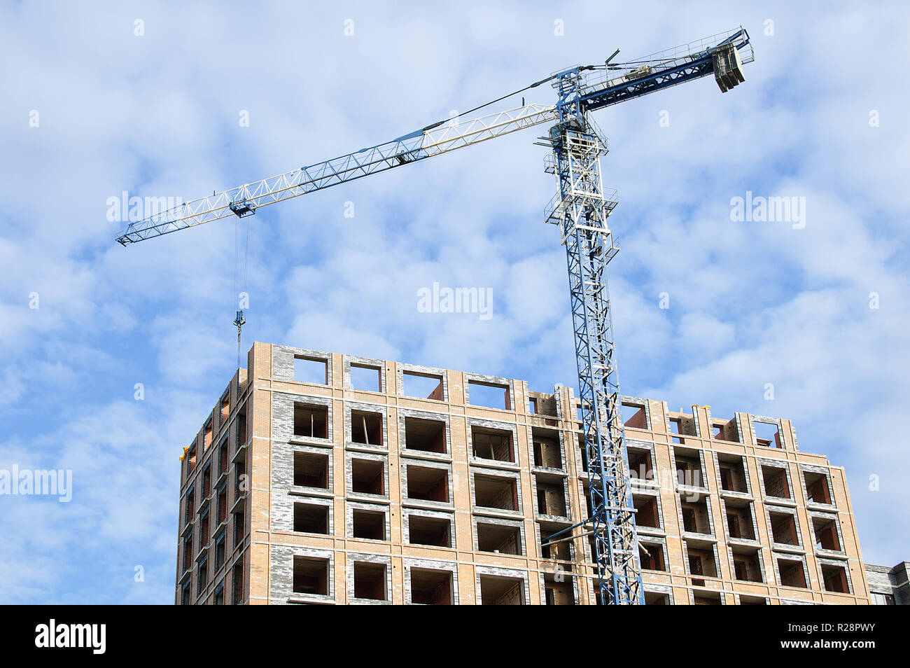 Lifting crane on the construction of a high-rise building Stock Photo ...