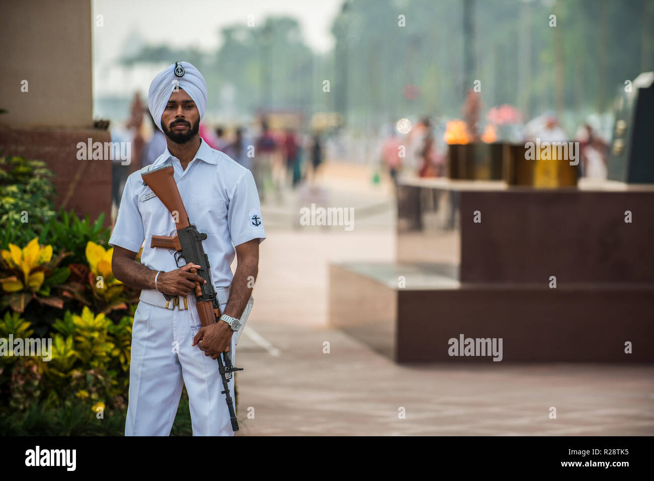 An armed soldier at The India Gate, a war memorial located astride the ...
