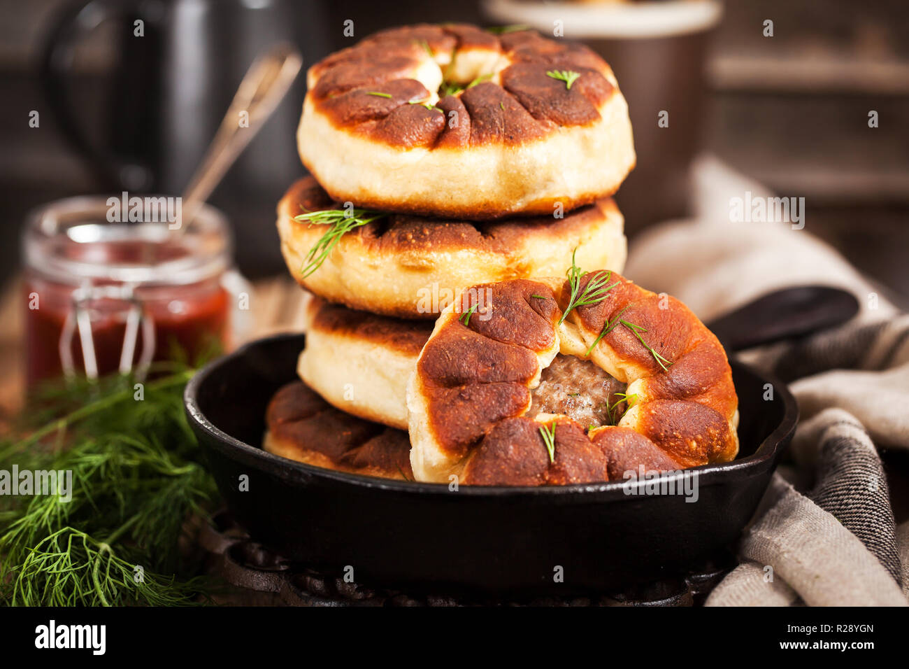 Traditional Russian deep fried meat patties (belyash) on rustic ...