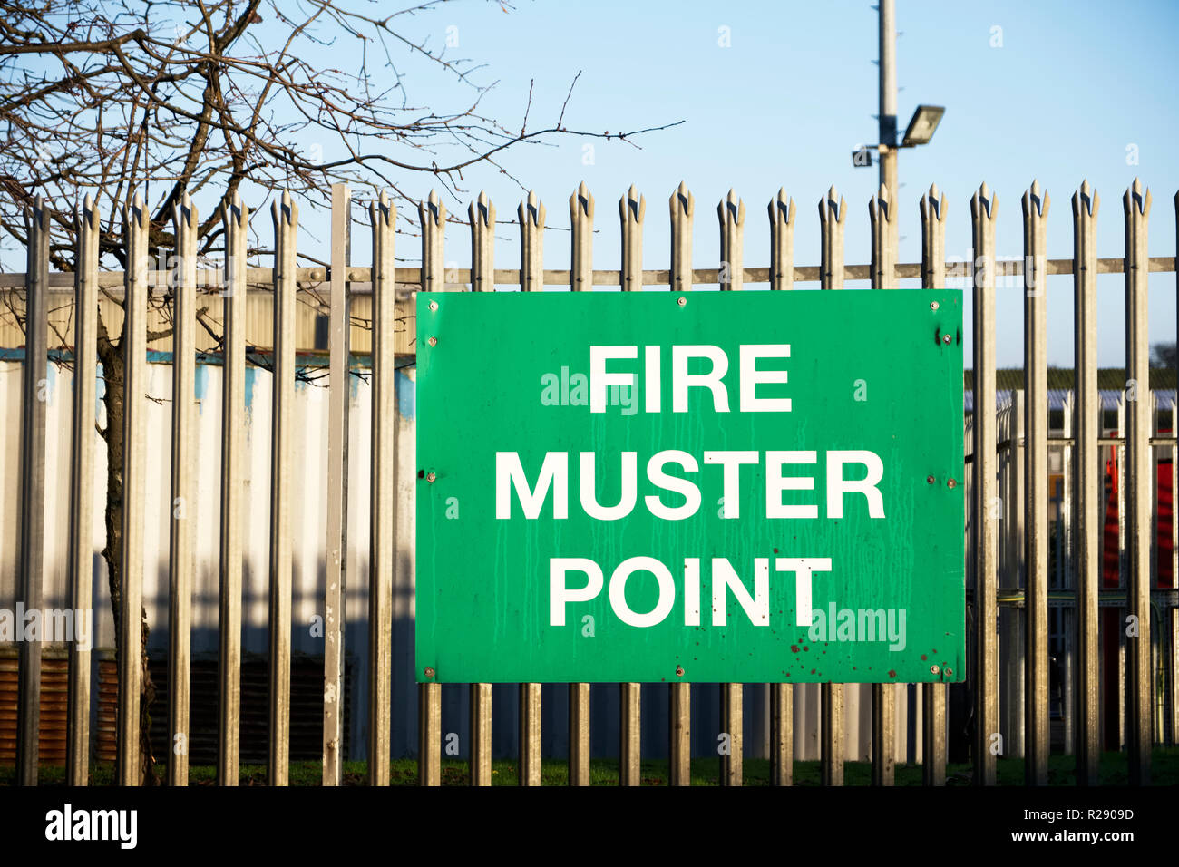 Fire muster assembly point sign at workplace car park fence Stock Photo ...