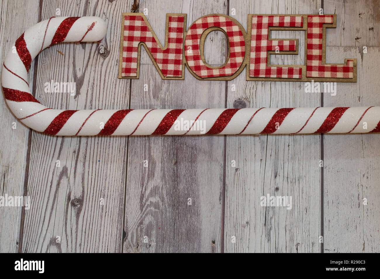 Christmas holiday flatlay with Noel word in red plaid, decorative candy ...