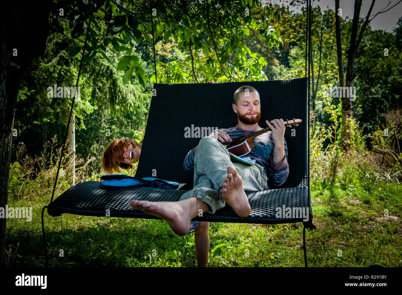 Couple relaxing on swing hi-res stock photography and images - Alamy