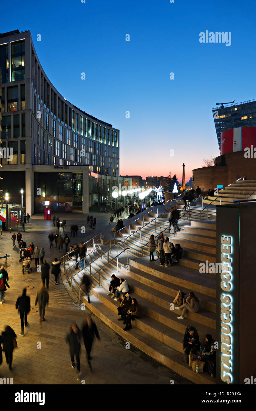 People walking about Chavasse Park Liverpool UK at dusk, taken from ...
