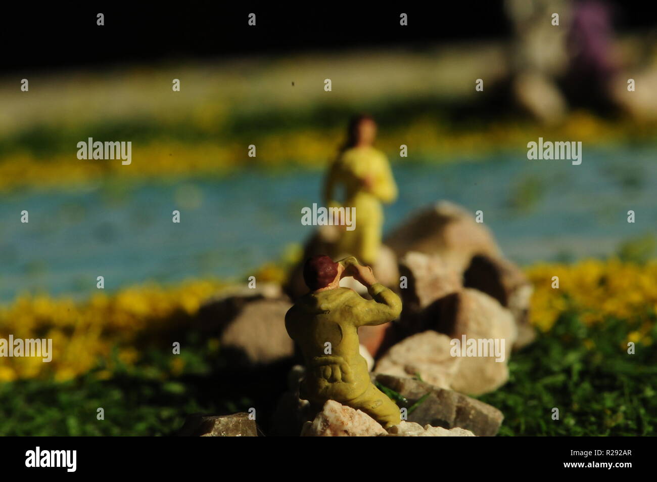 miniature figures woman and man taking fotos at the lake Stock Photo ...
