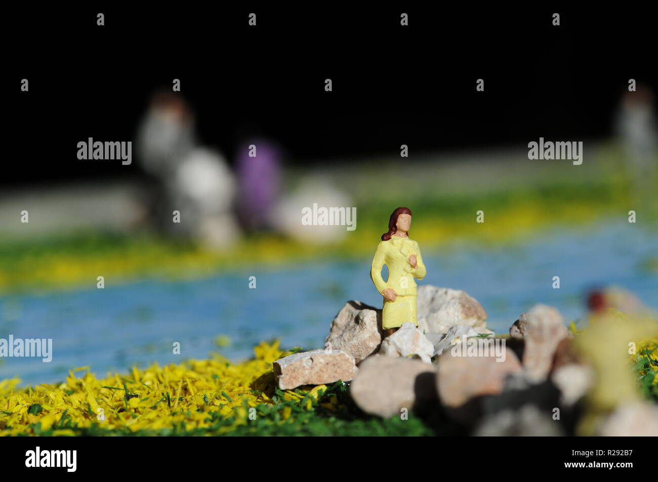 miniature figures woman and man taking fotos at the lake Stock Photo ...