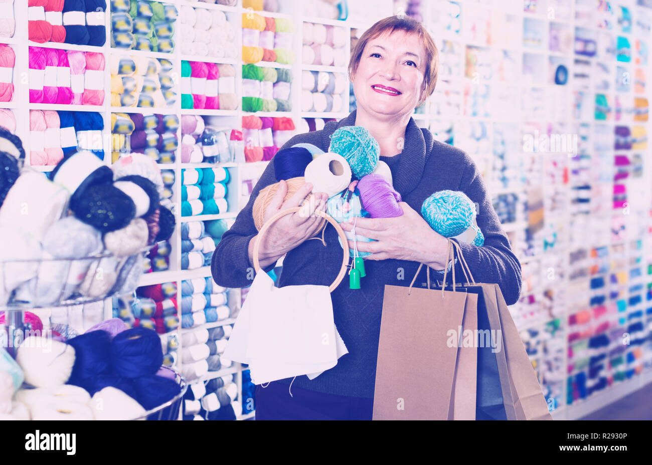 Female is standing with purchases in needlework store Stock Photo - Alamy