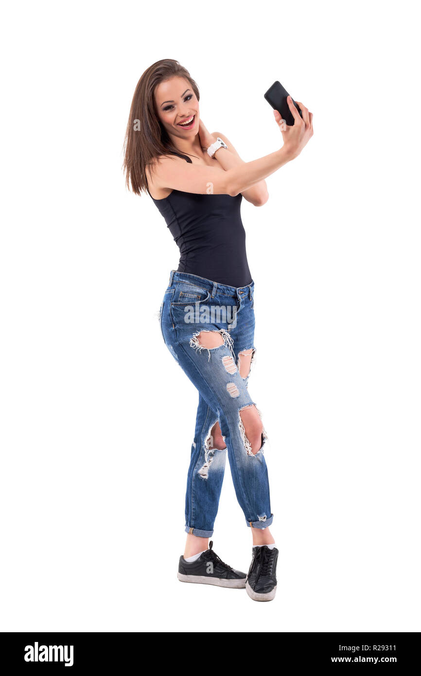 Relaxed young beautiful happy woman having fun with mobile phone camera ...
