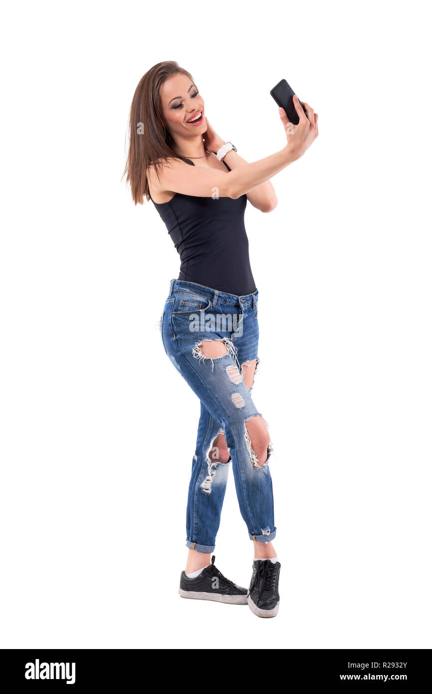 Relaxed young beautiful woman taking selfie and sending photo messages ...