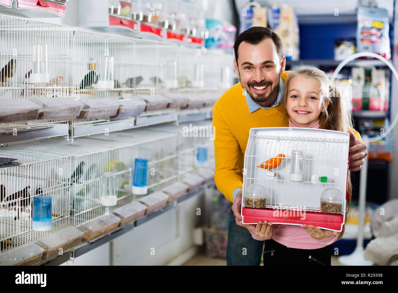 Smiling cheerful positive father and daughter boasting their purchase ...