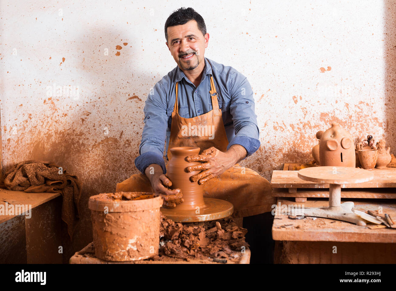 Happy mature man making pot using pottery wheel in studio Stock Photo ...